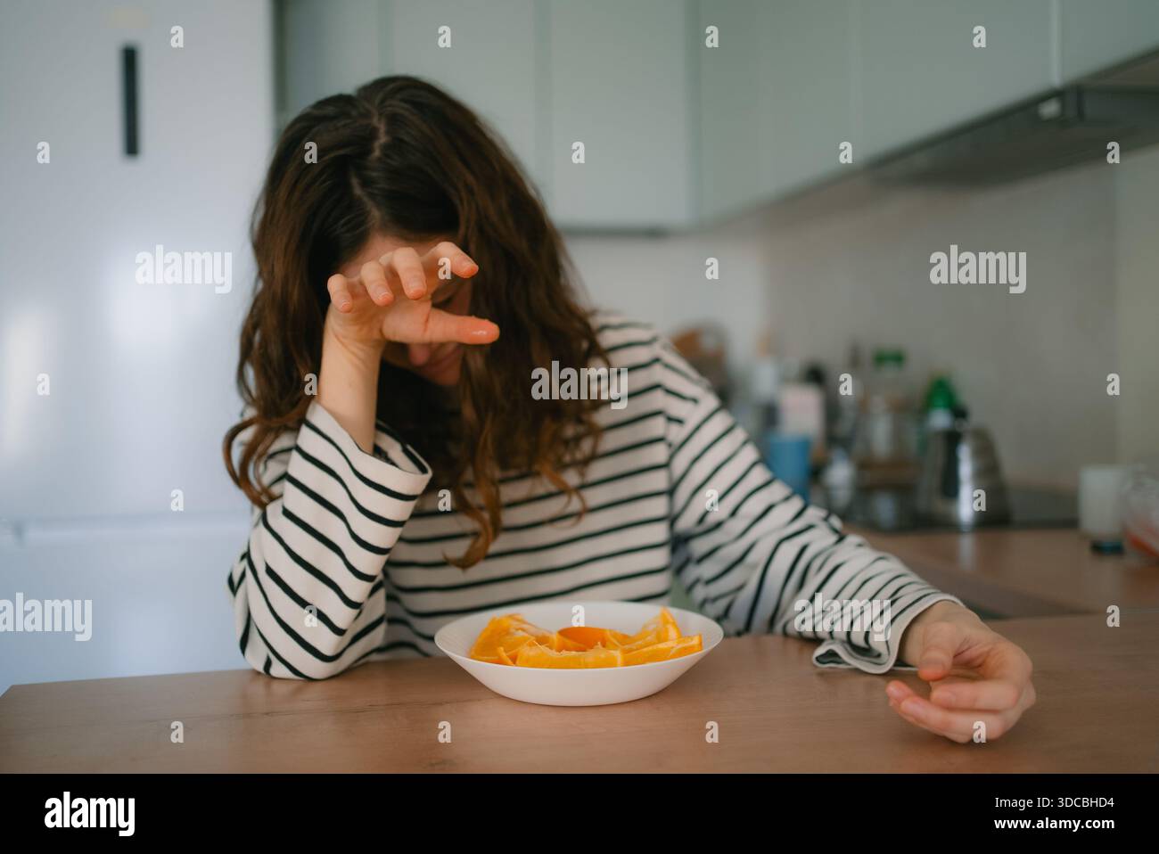 Woman feeling symptoms of toxicosis and aversion to food, closing her ...