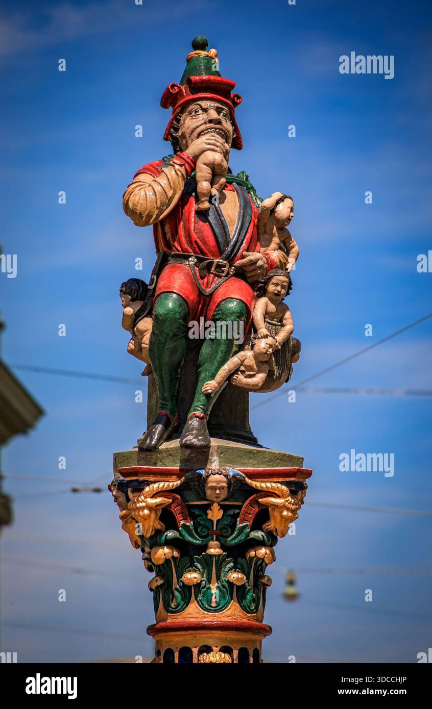 Colorful Kindlifresserbrunnen statue of an ogre devouring children on a ...