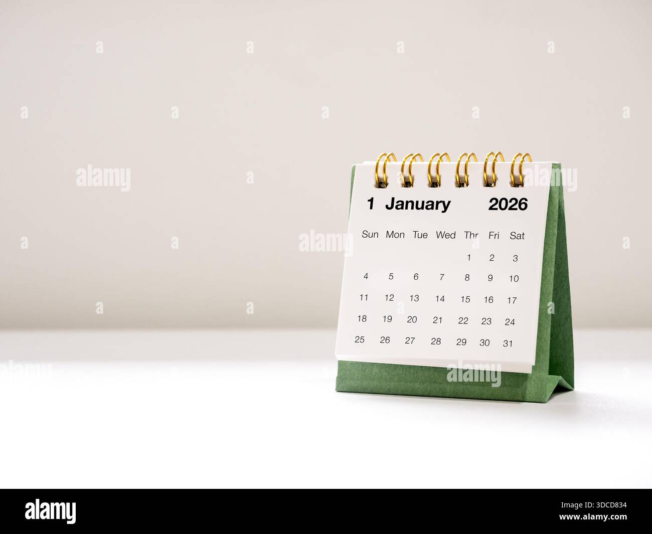 Close-up of desk calendar showing January 2026 with golden rings and ...