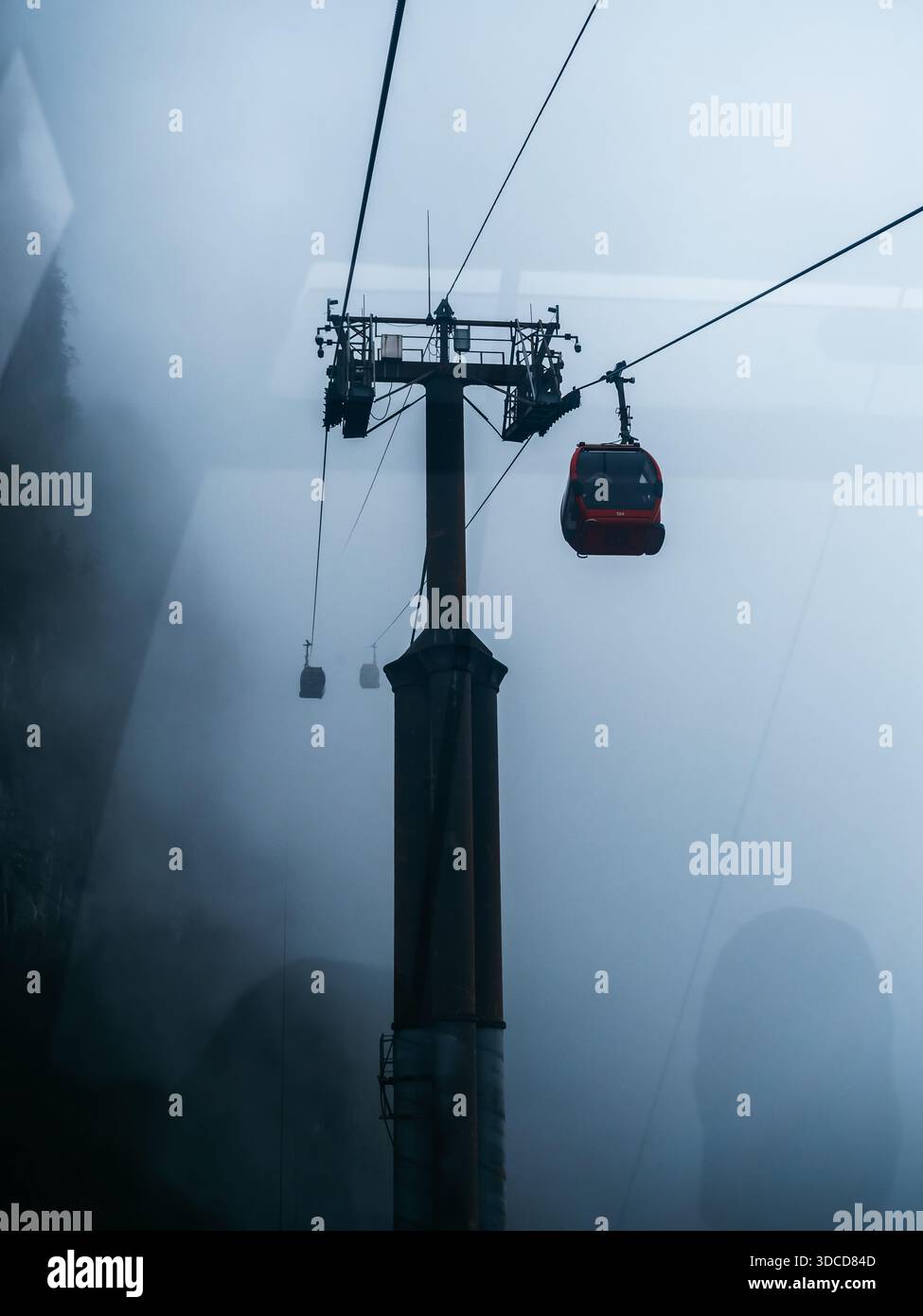 Scenic view from a cable car ascending a misty Tianmen Mountain ...