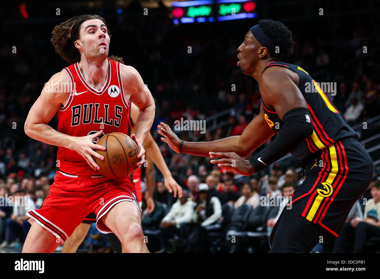 Chicago Bulls guard Josh Giddey, left, dribbles against Atlanta Hawks ...