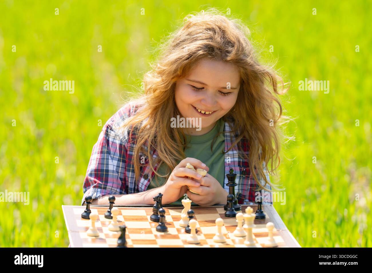 Kid plays chess. A child thinks and playing chess. Kid focuses on ...