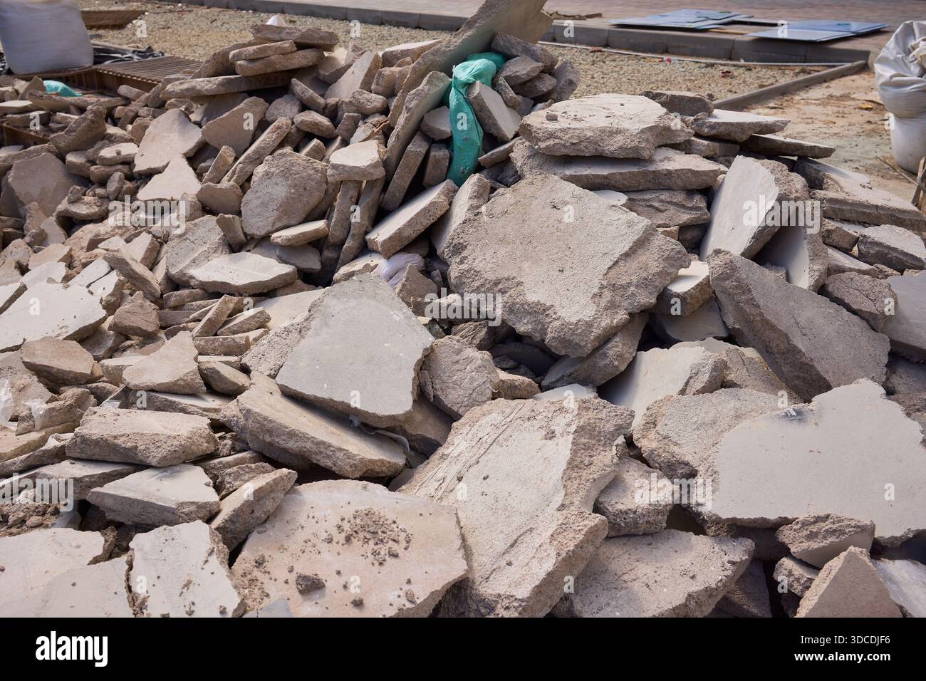 A chaotic mound of broken concrete shows various construction waste ...