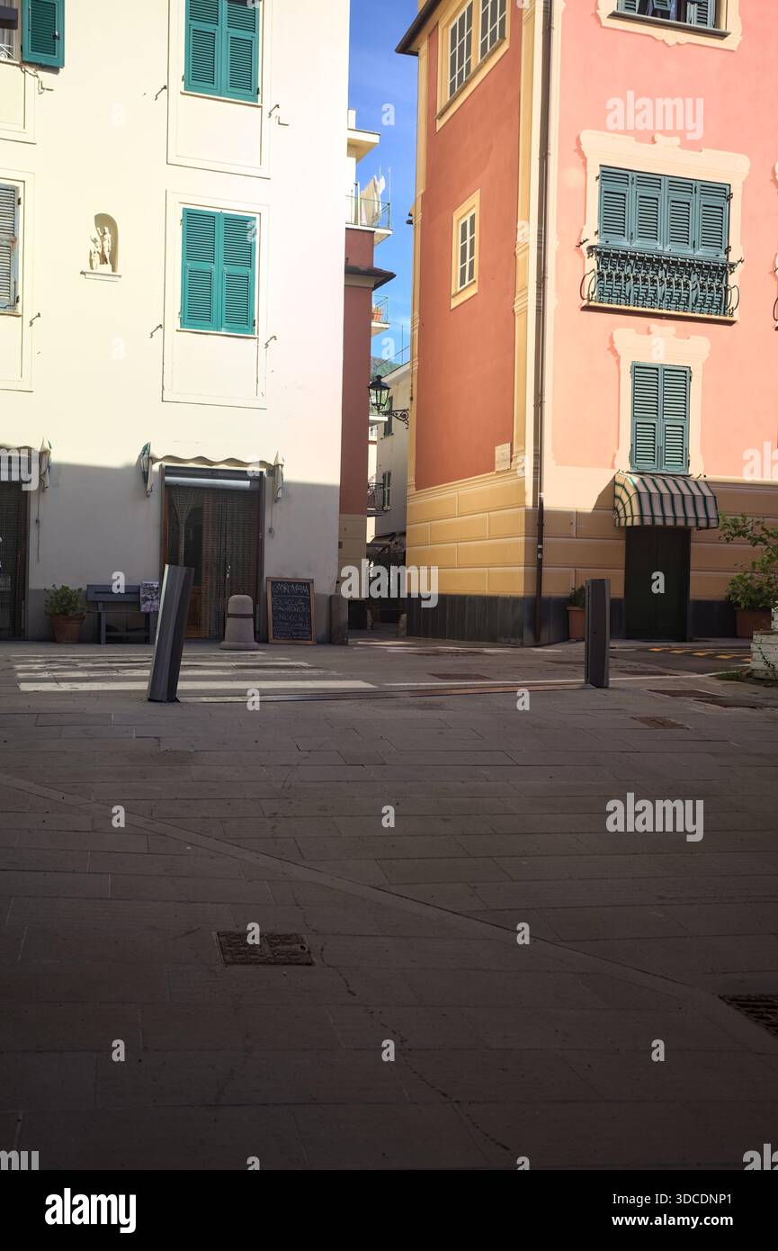 Alley in the shade with a pedestrian crossing leading to an another ...