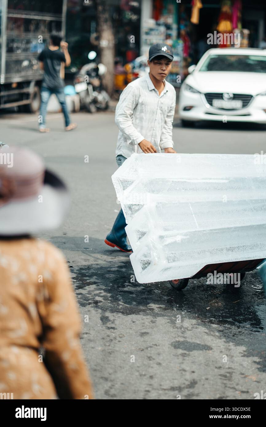 Hanoi, Vietnam December 4 2019. Block ice delivery man on the streets ...