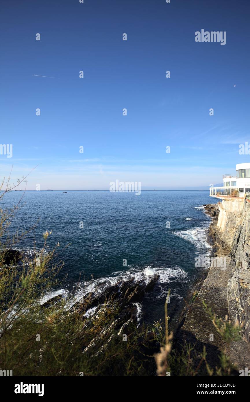 Promenade with an azure railing over a cliff with the sea down below ...