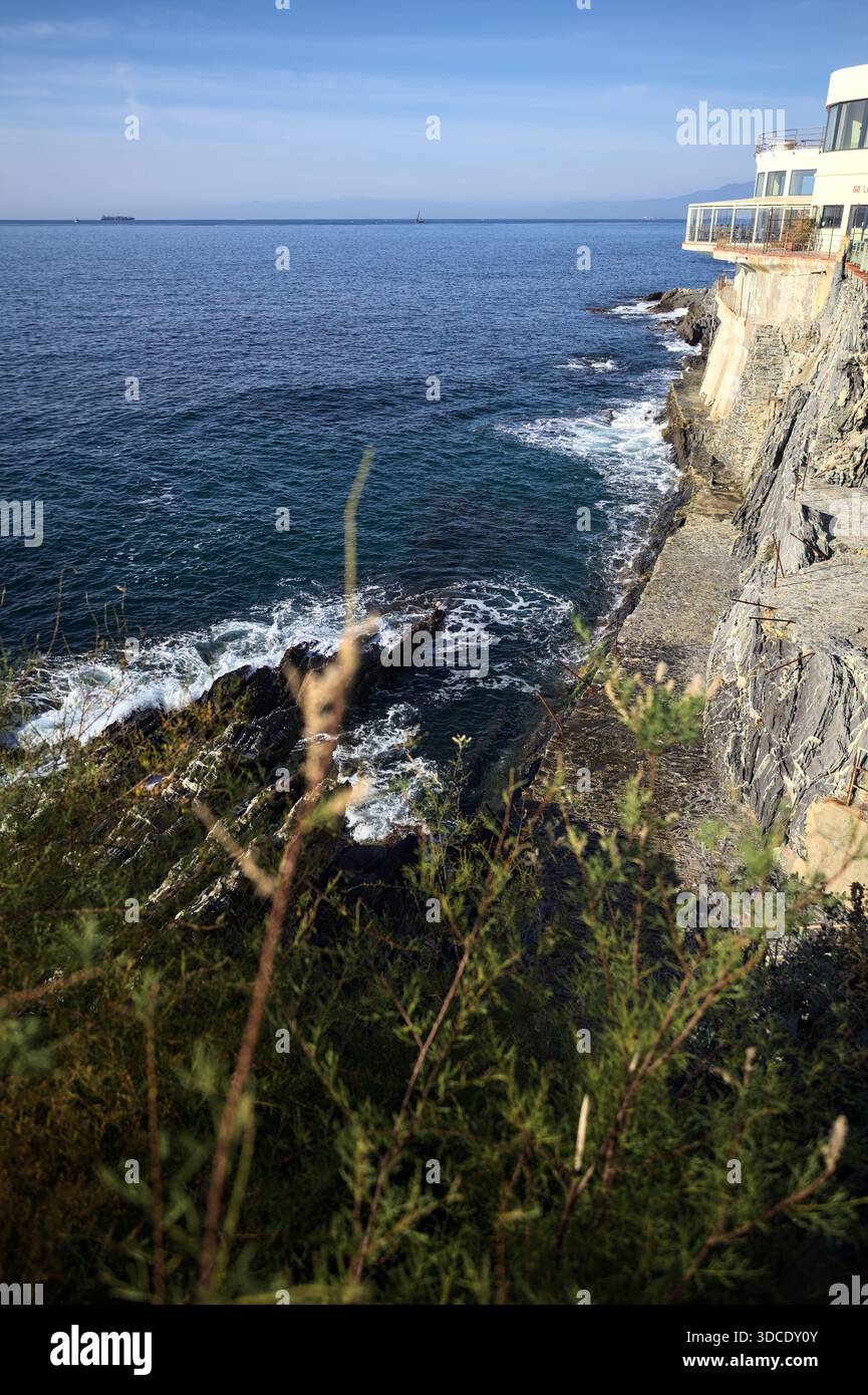 Promenade with an azure railing over a cliff with the sea down below ...