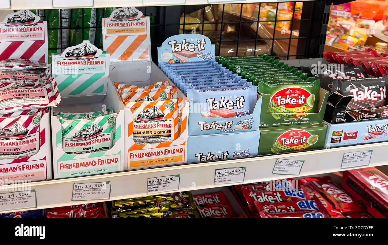 Candies of various types and brands in packets for sale on Indonesian ...