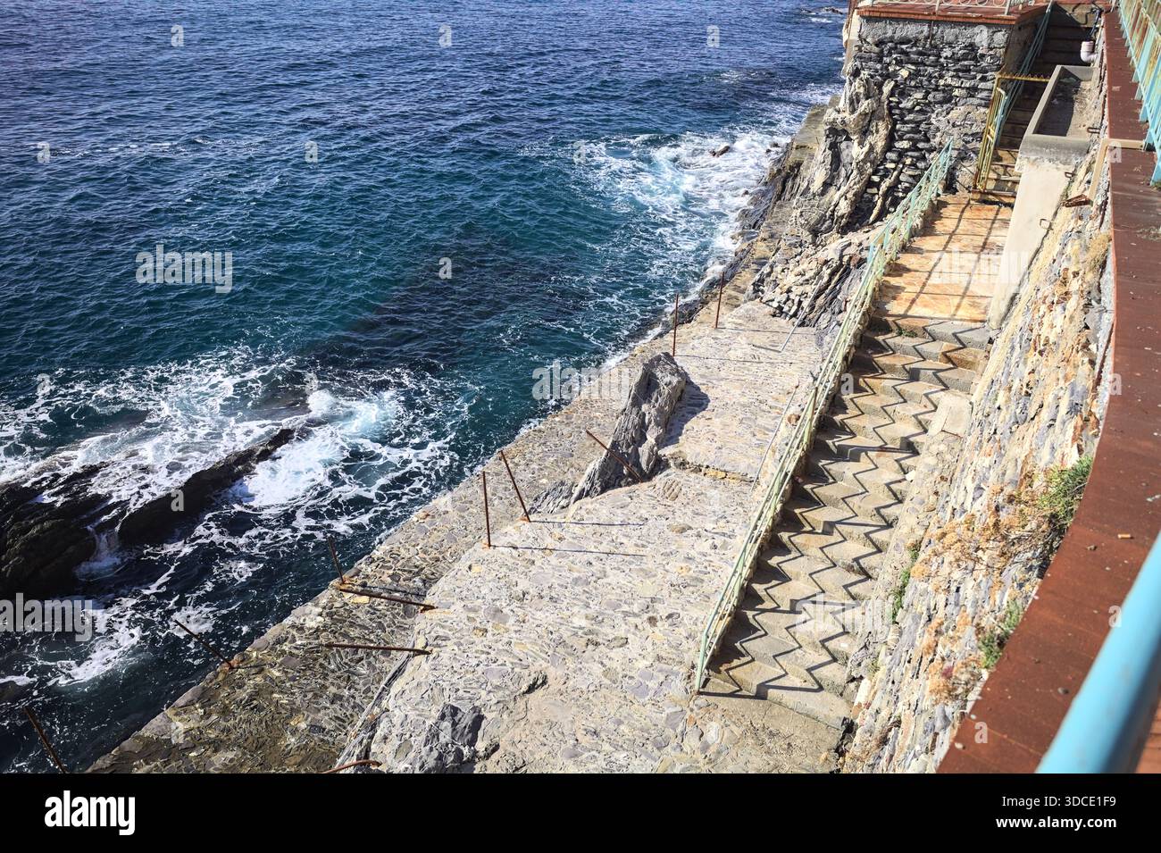 Terrace on a cliff over the sea with staircases leading to the water ...