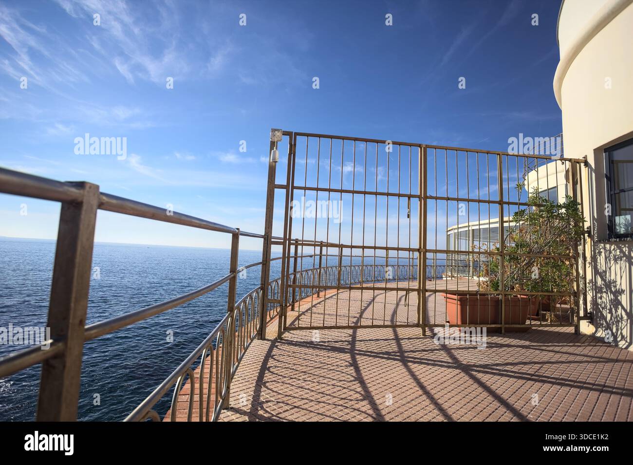Closed gate in a fence of a building leading to a panoramic terrace of ...