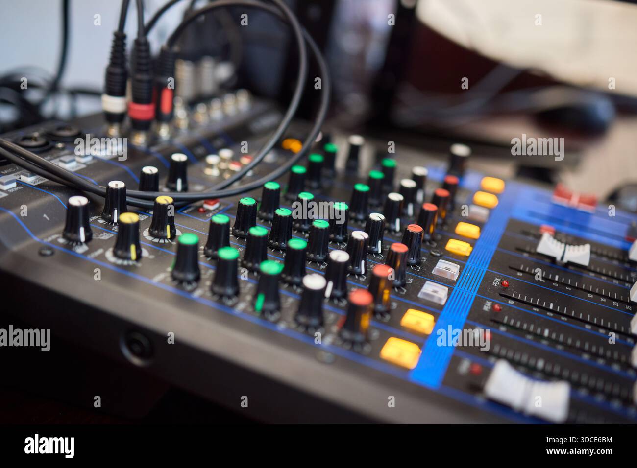 A closeup of a hand skillfully adjusting audio settings on a digital ...