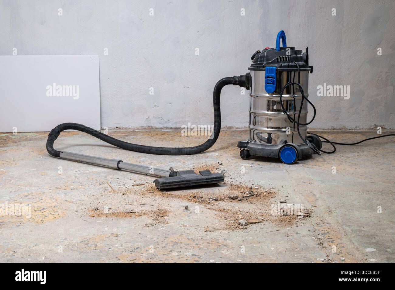 Industrial vacuum cleaner on a concrete floor with debris Stock Photo ...