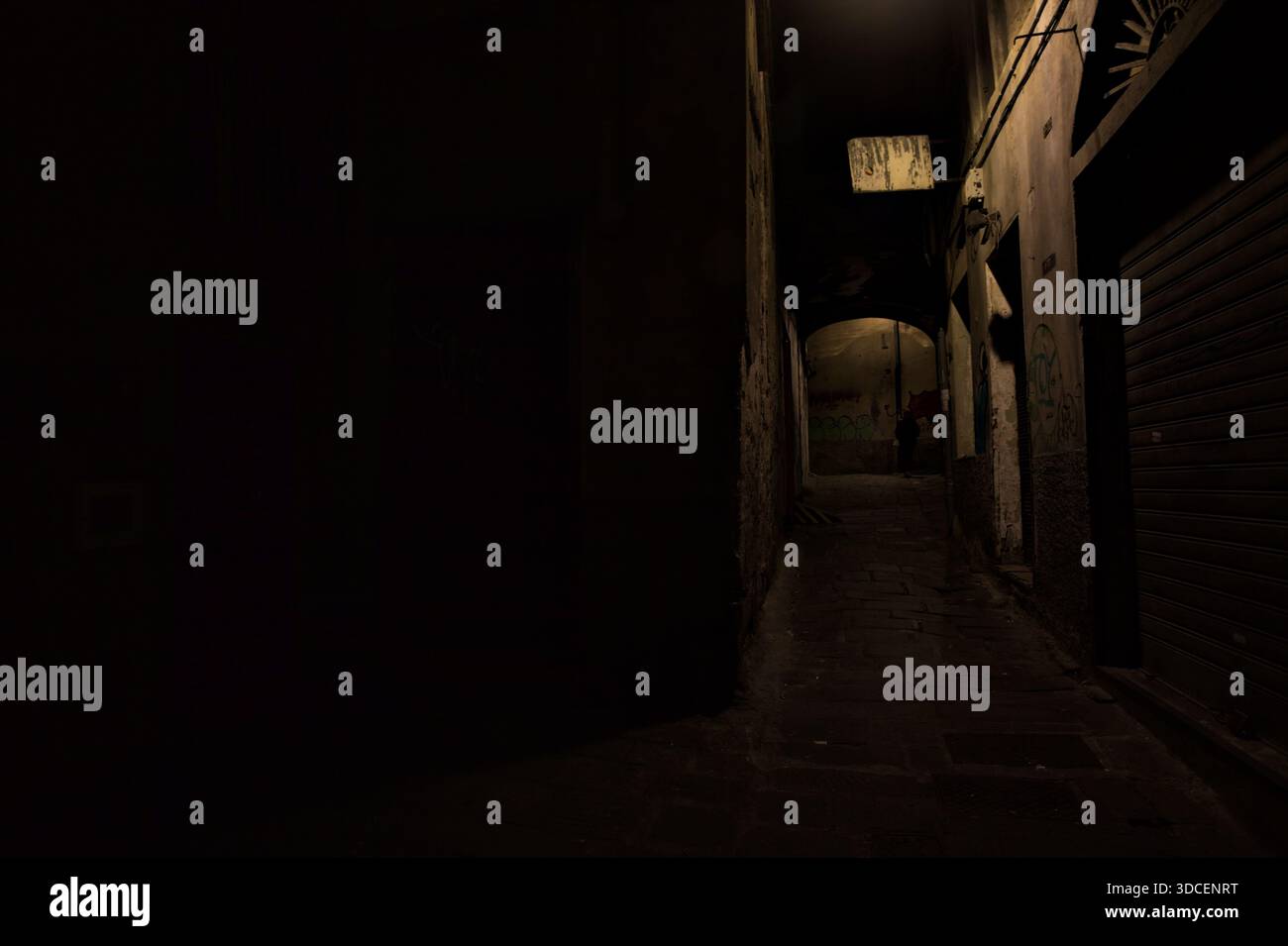 Alley ending in an archway and making an opening with a sharp angle to ...