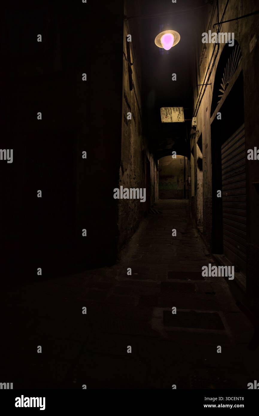 Alley ending in an archway and making an opening with a sharp angle to ...