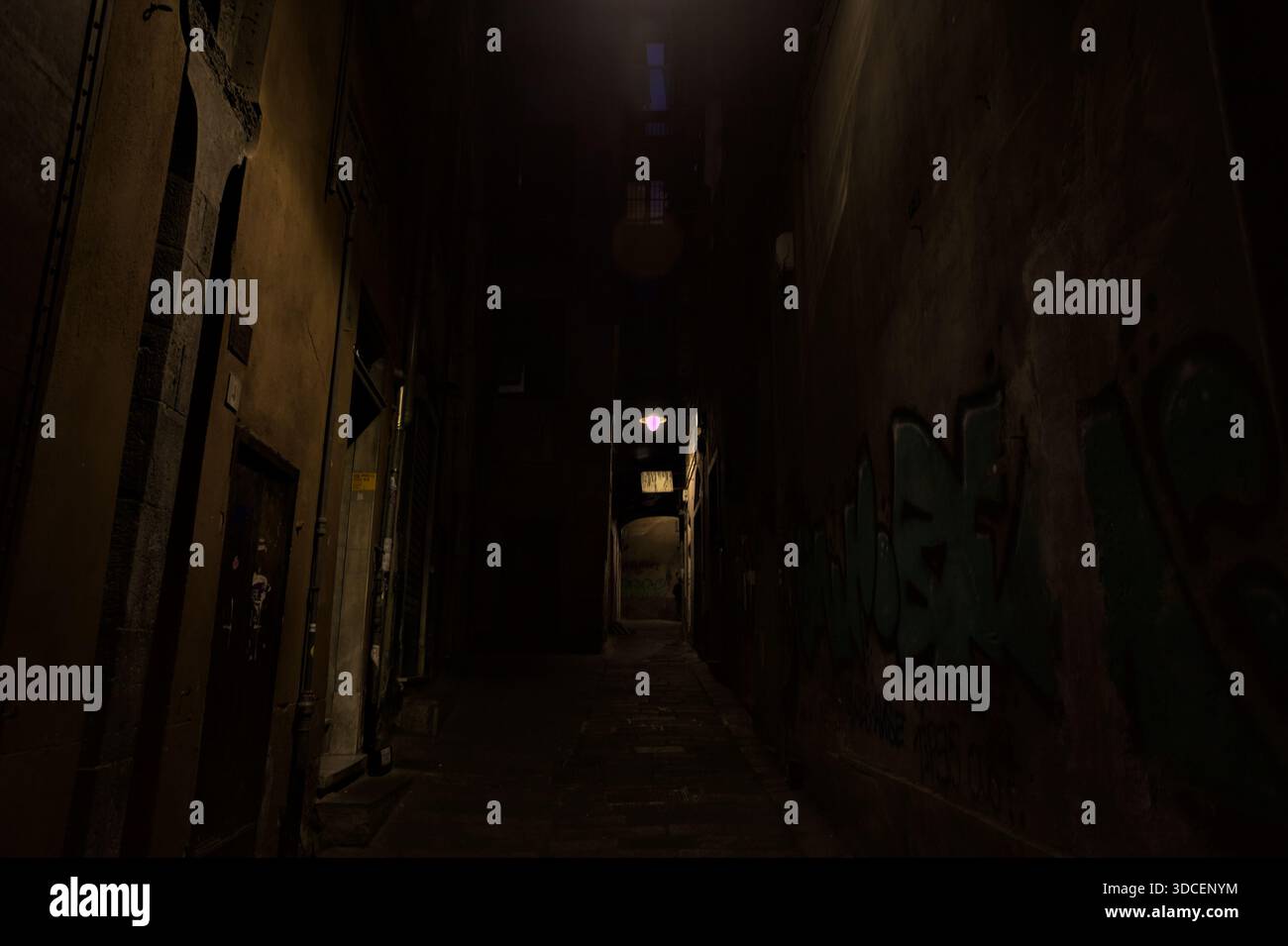 Alley ending in an archway and making an opening with a sharp angle to ...