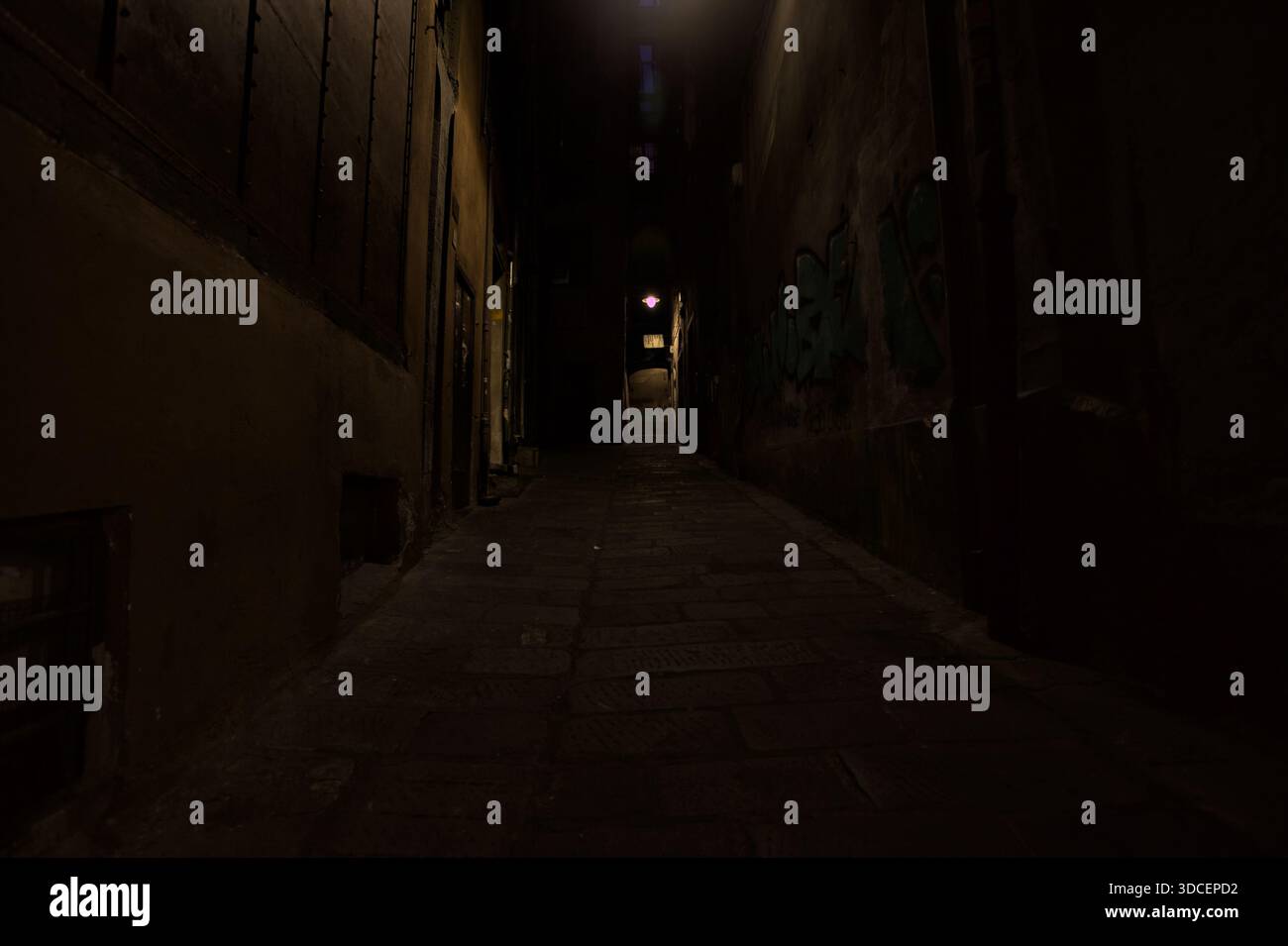 Alley ending in an archway and making an opening with a sharp angle to ...
