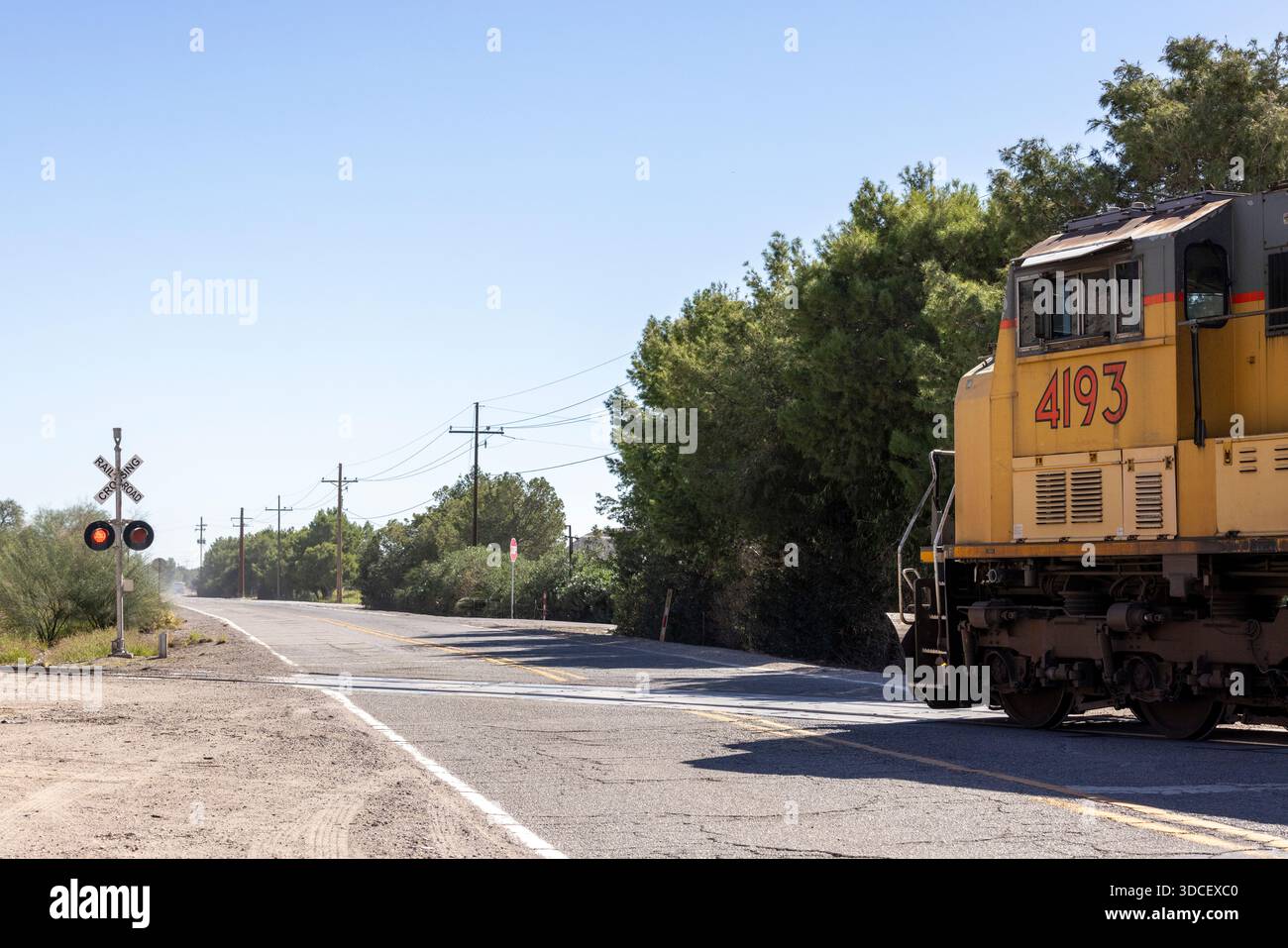Train entering road crossing hi-res stock photography and images - Alamy