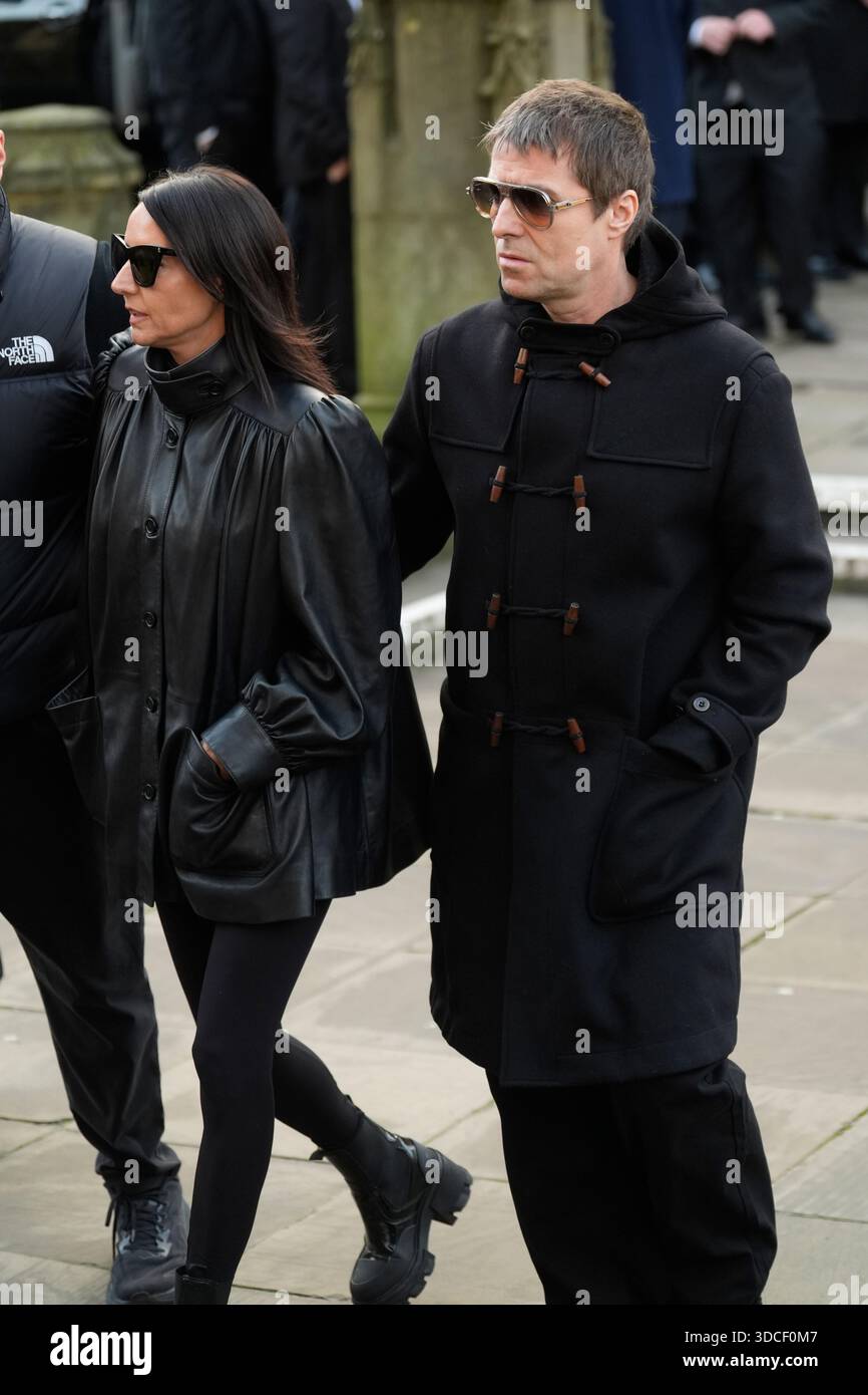 Liam Gallagher and his partner Debbie Gwyther arriving for the funeral ...