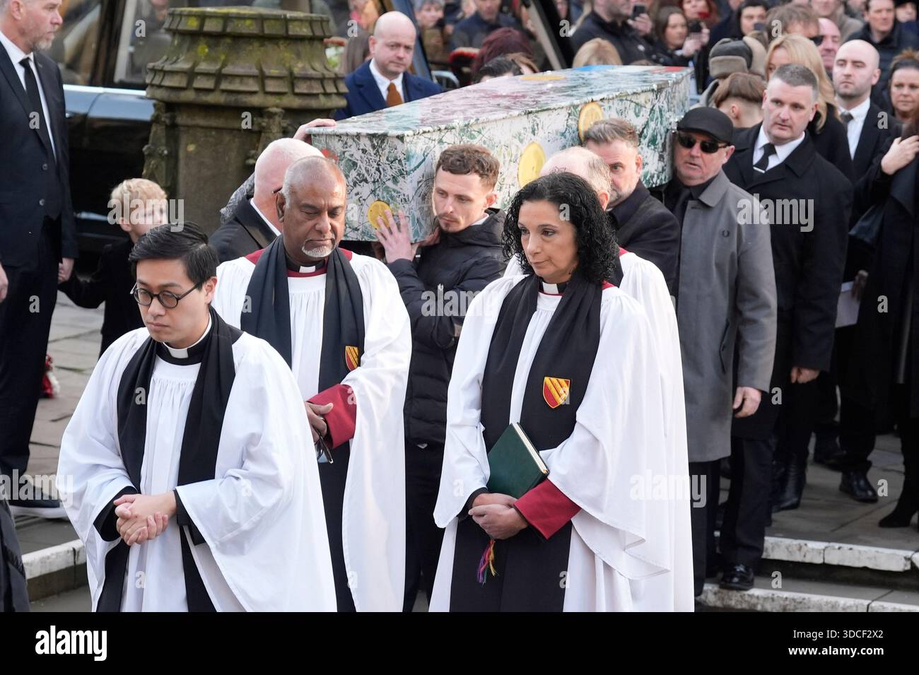 The bearer party carry the coffin decorated in the iconic artwork 'Bye ...