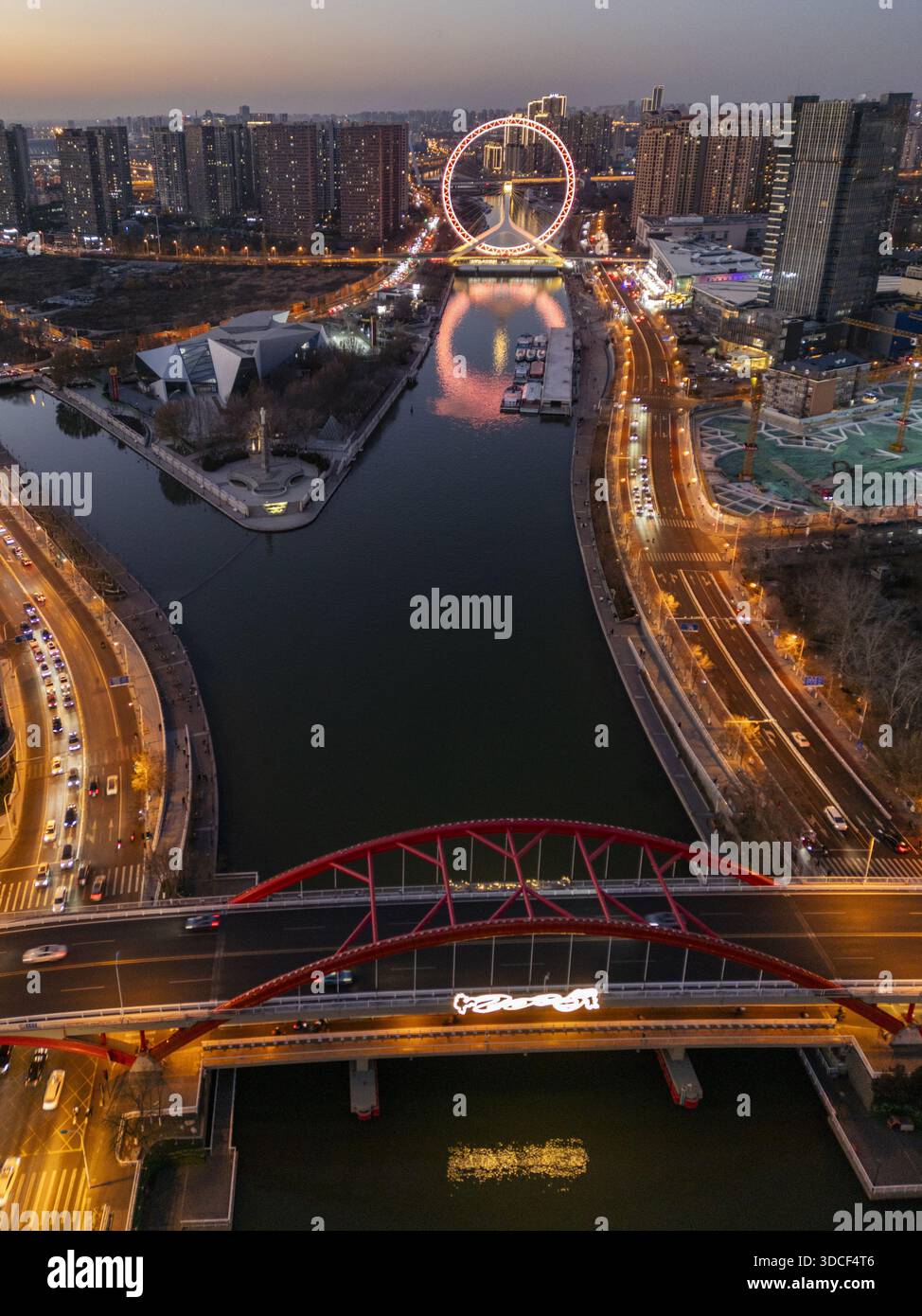 Aerial view of the Tianjin Eye Ferris wheel reflecting in the Hai River ...