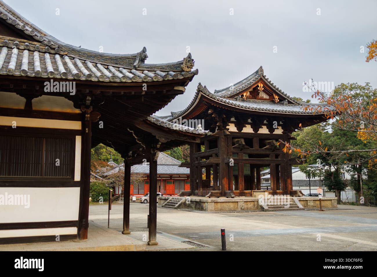 Historic wooden temple gate in Japan features a large bronze bell ...
