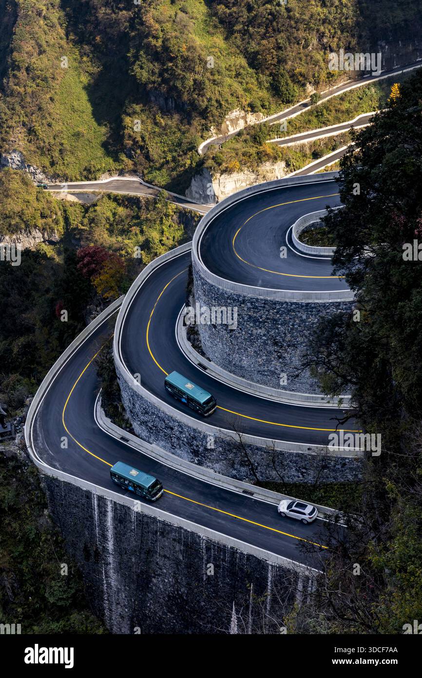 View of winding roads hugging the mountainside as vehicles navigate the ...