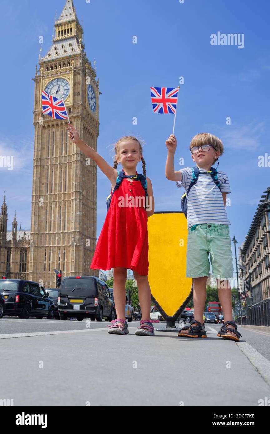 two children joyfully raising flags of Britain, framed by the historic ...