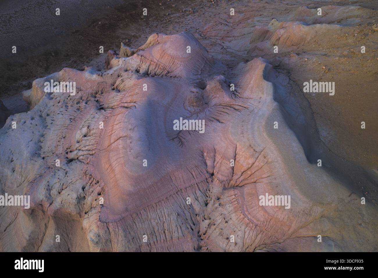 Aerial view of eroded rock formations displaying layered strata in ...