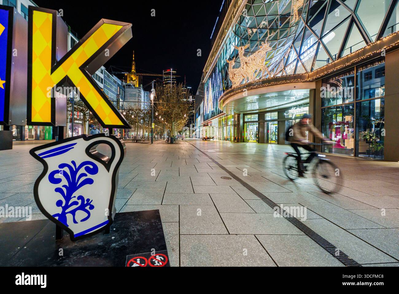 22 December 2025, Hesse, Frankfurt/Main: A man cycles along the Zeil ...