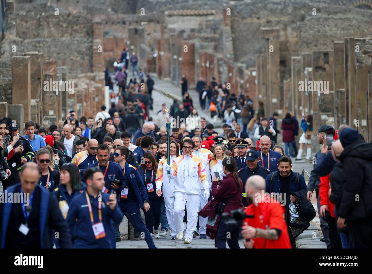 Actor Jackie Chan holds the olympic torch passing through the ...