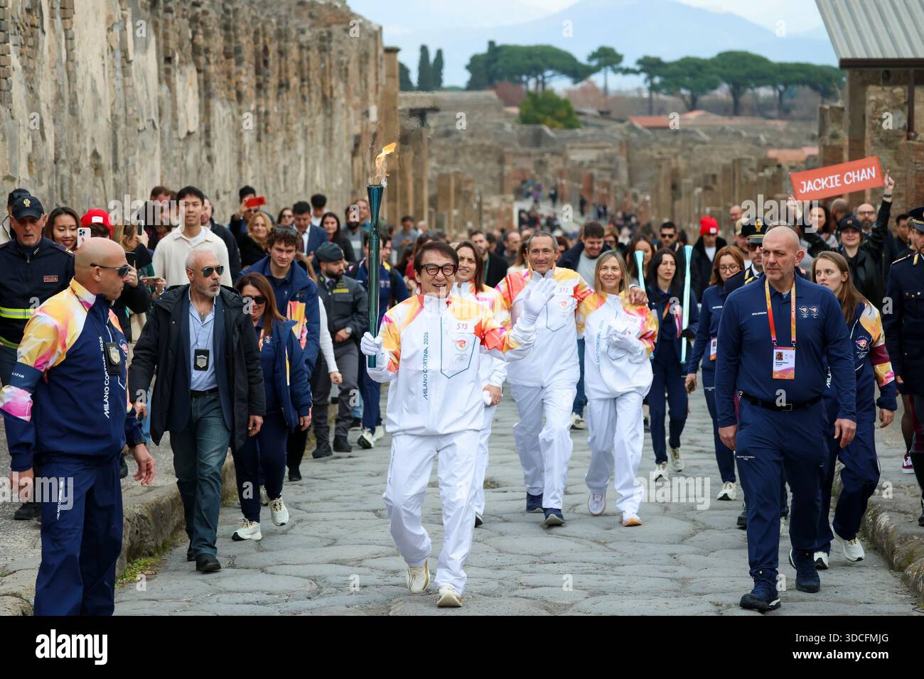 Actor Jackie Chan holds the olympic torch passing through the ...