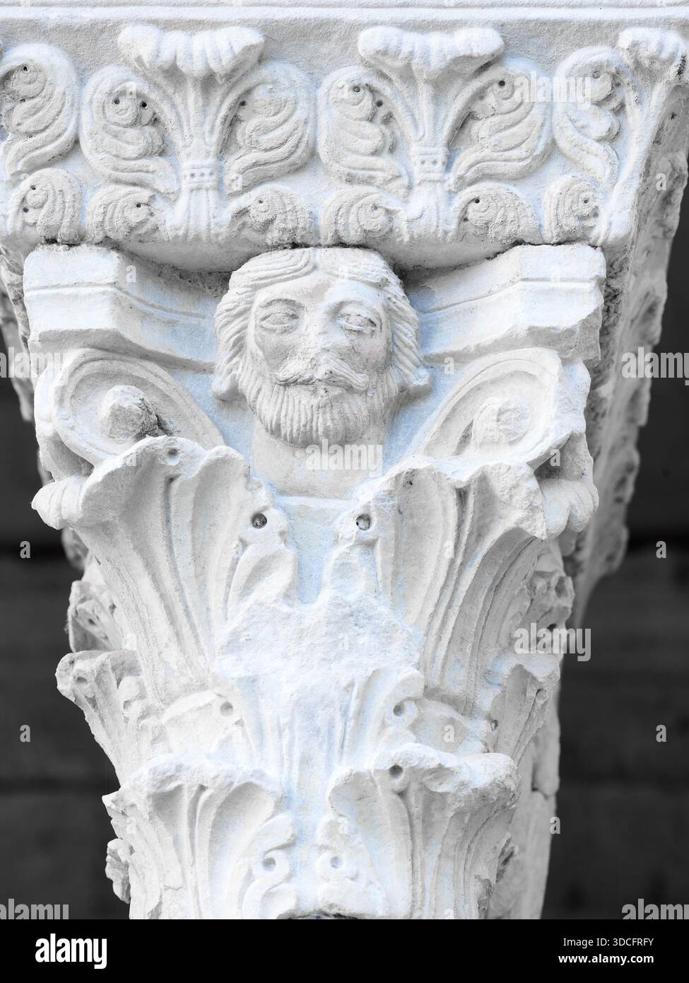 Carved chapter, of a male face, on a pillar in the cloister of St ...