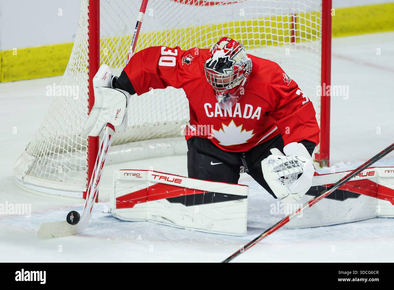 Canadian goaltender Carter George (30) makes a save against Sweden in ...