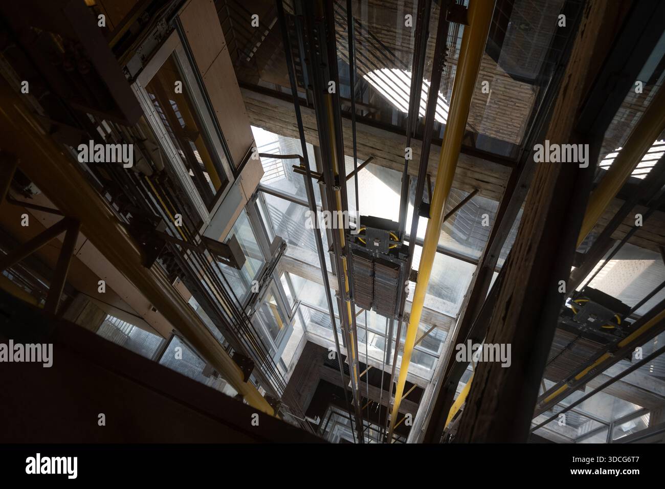 Aerial view of an industrial elevator shaft with glass walls and metal ...