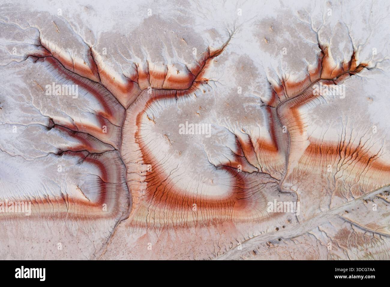 Aerial view of a parched landscape, where fiery red veins cut through ...