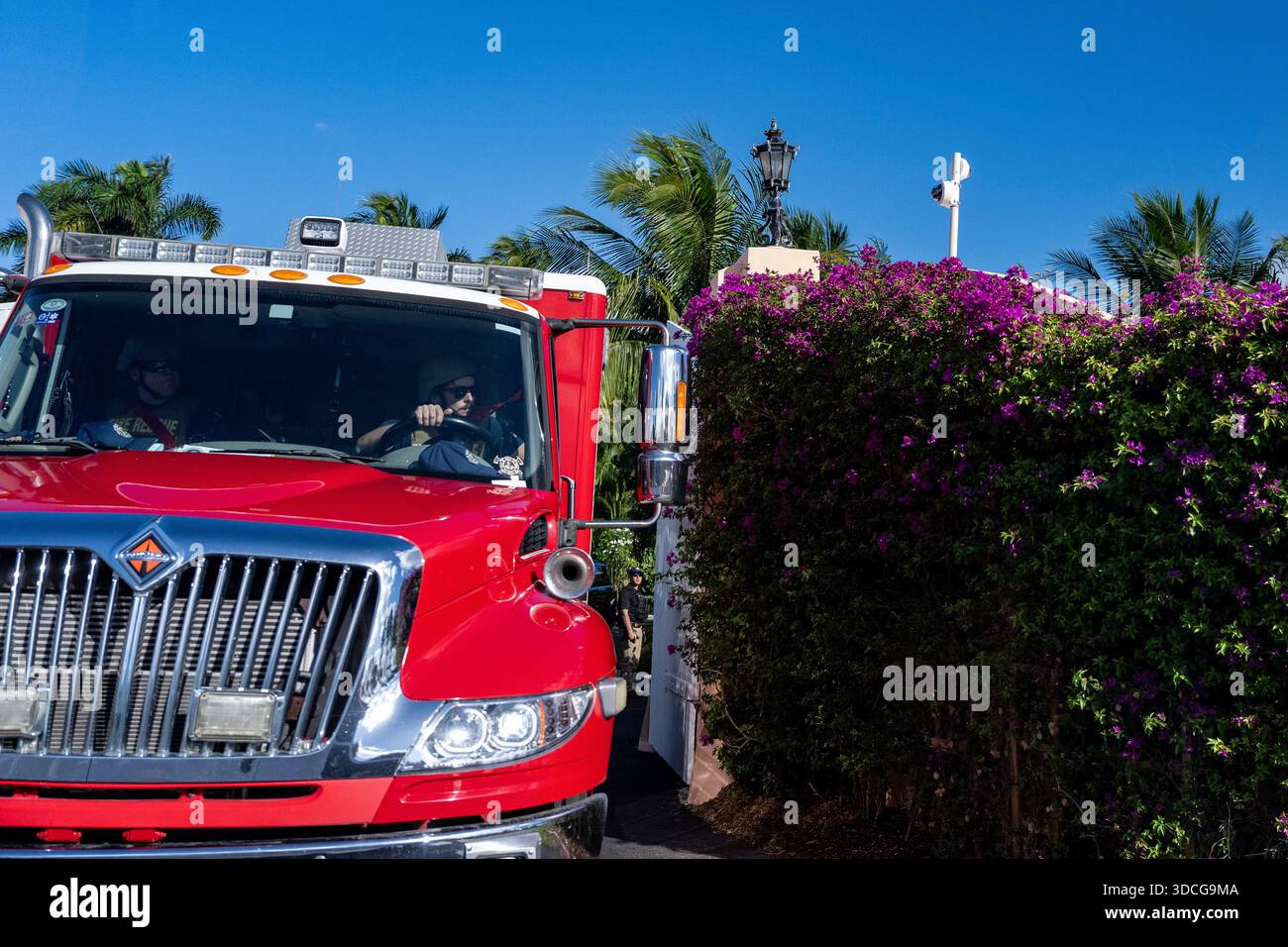 An ambulance with first responders in kevlar helmets and body armor ...