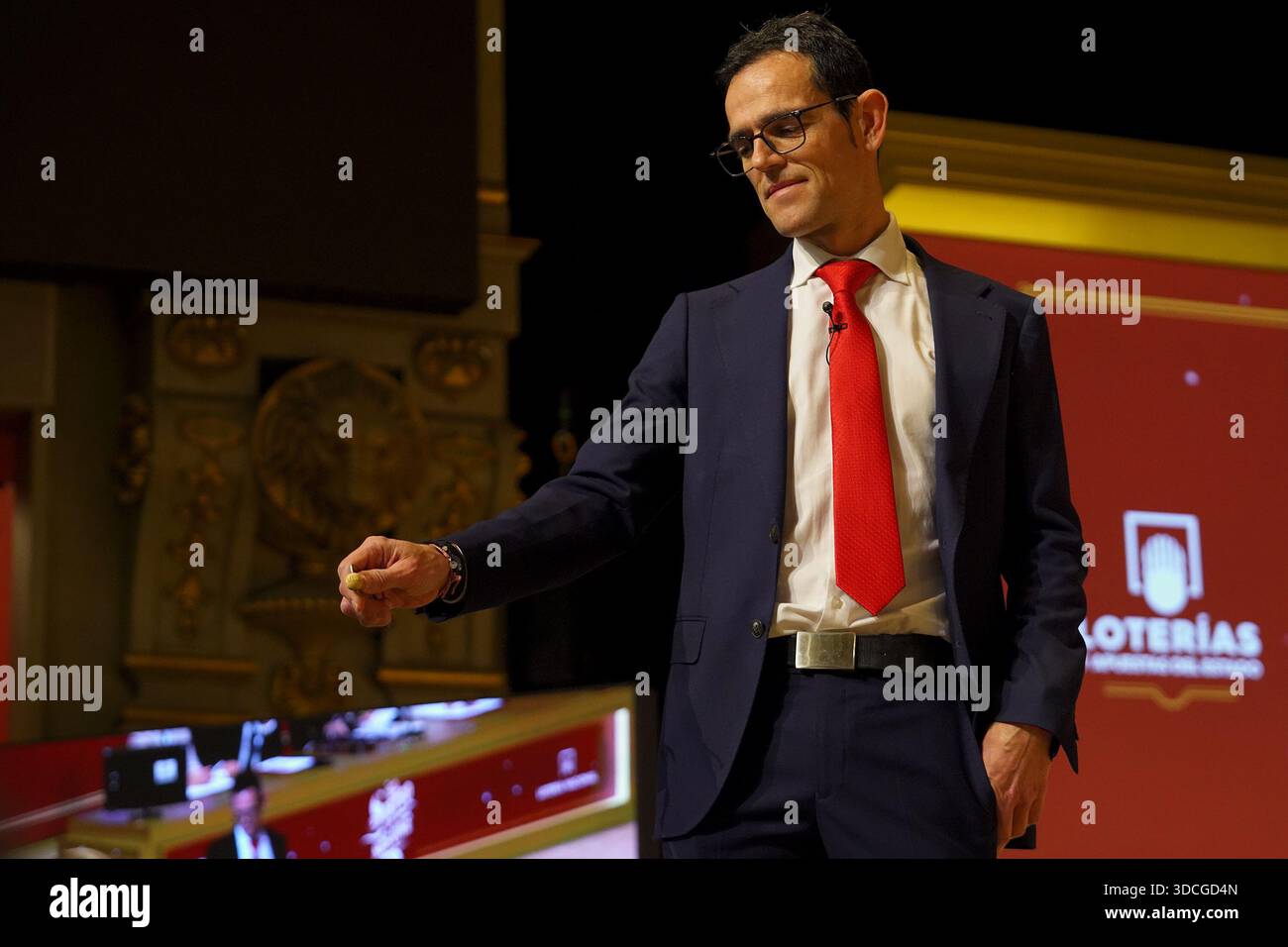 A man puts the balls with the prizes into the lottery drum during the ...