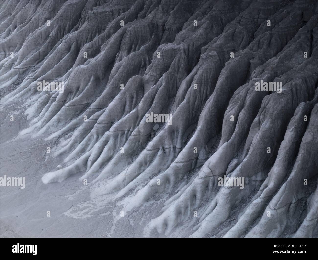 Aerial view of the stark, grey-white textured landscape reveals deep ...