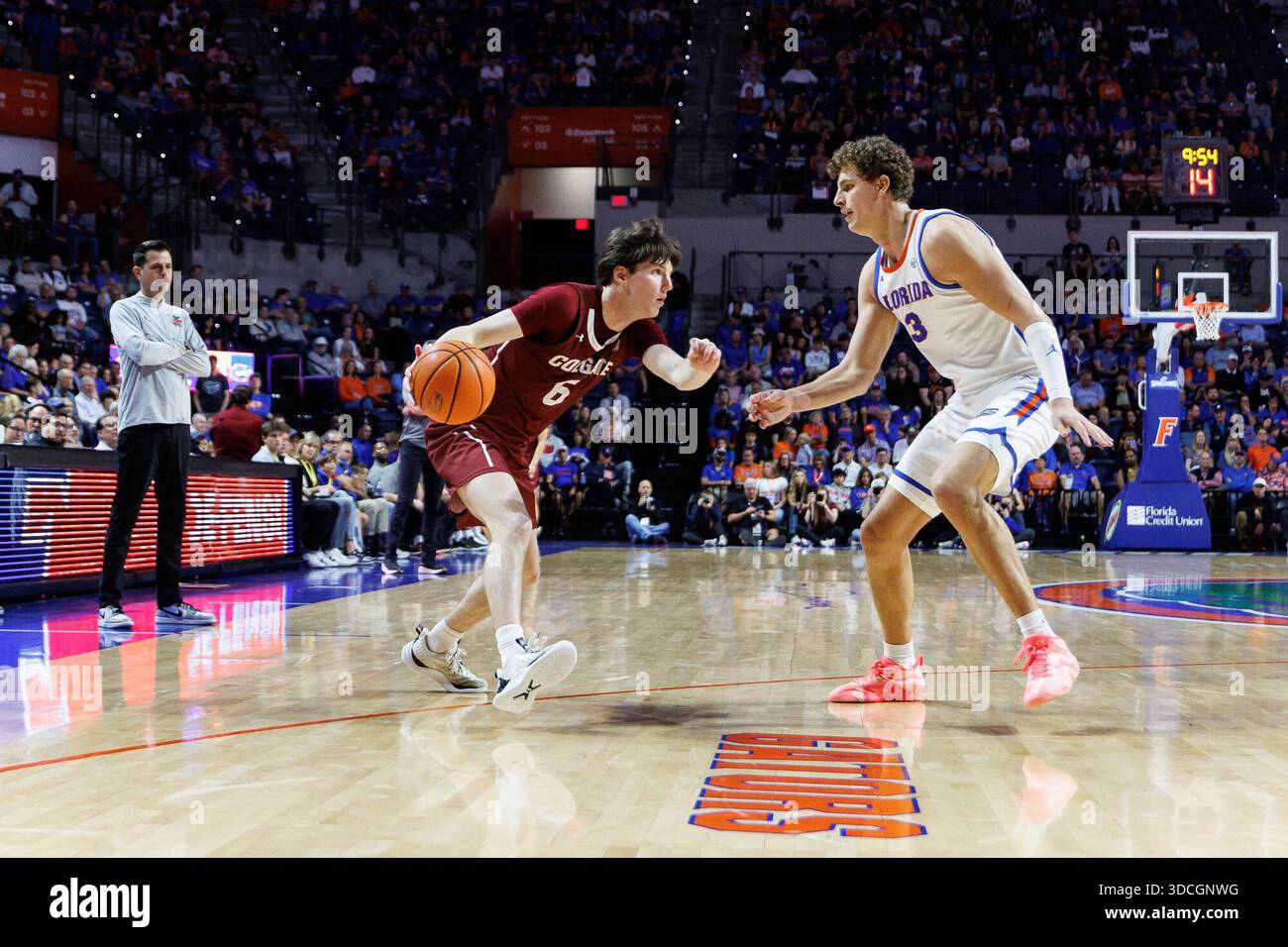 Florida center Micah Handlogten (3) defends Colgate guard Ben Tweedy (6 ...