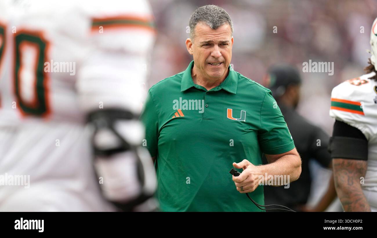 Miami head coach Mario Cristobal warms up his team before the first ...