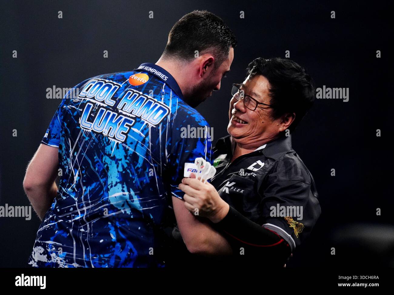 England's Luke Humphries (left) celebrates defeating Singapore's Paul ...