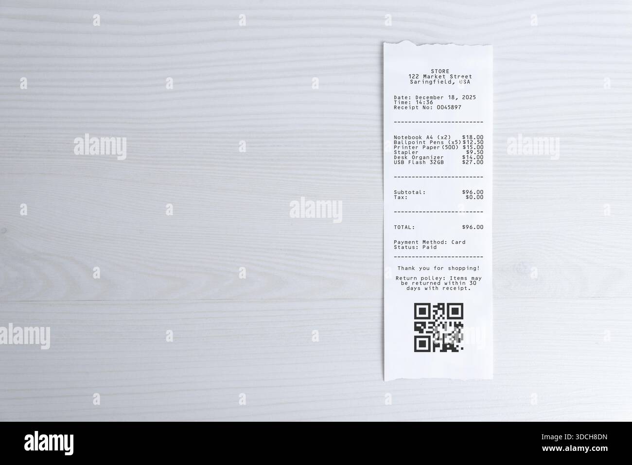 Paper receipt with qr code on white desk, expense documentation concept ...