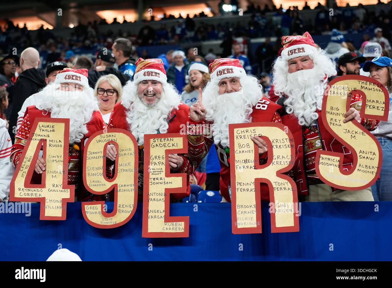 San Francisco 49ers fans dressed as Santa Claus pose for photos before ...