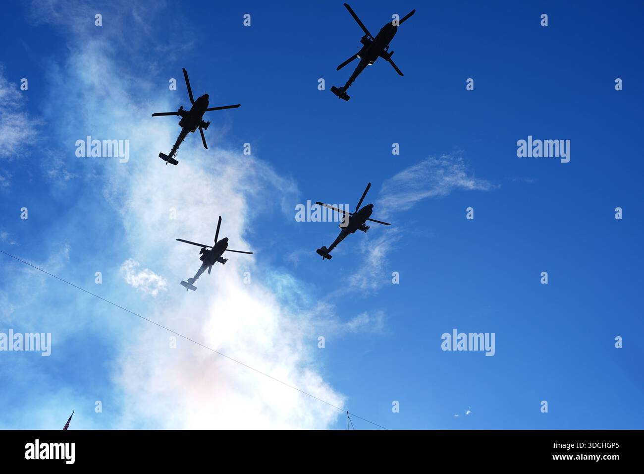 Apache helicopters take part in a flyover before the first half of an ...
