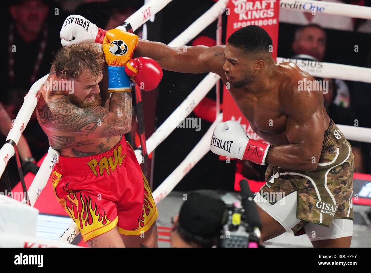 Jake Paul, left, and Anthony Joshua, right, compete during their ...