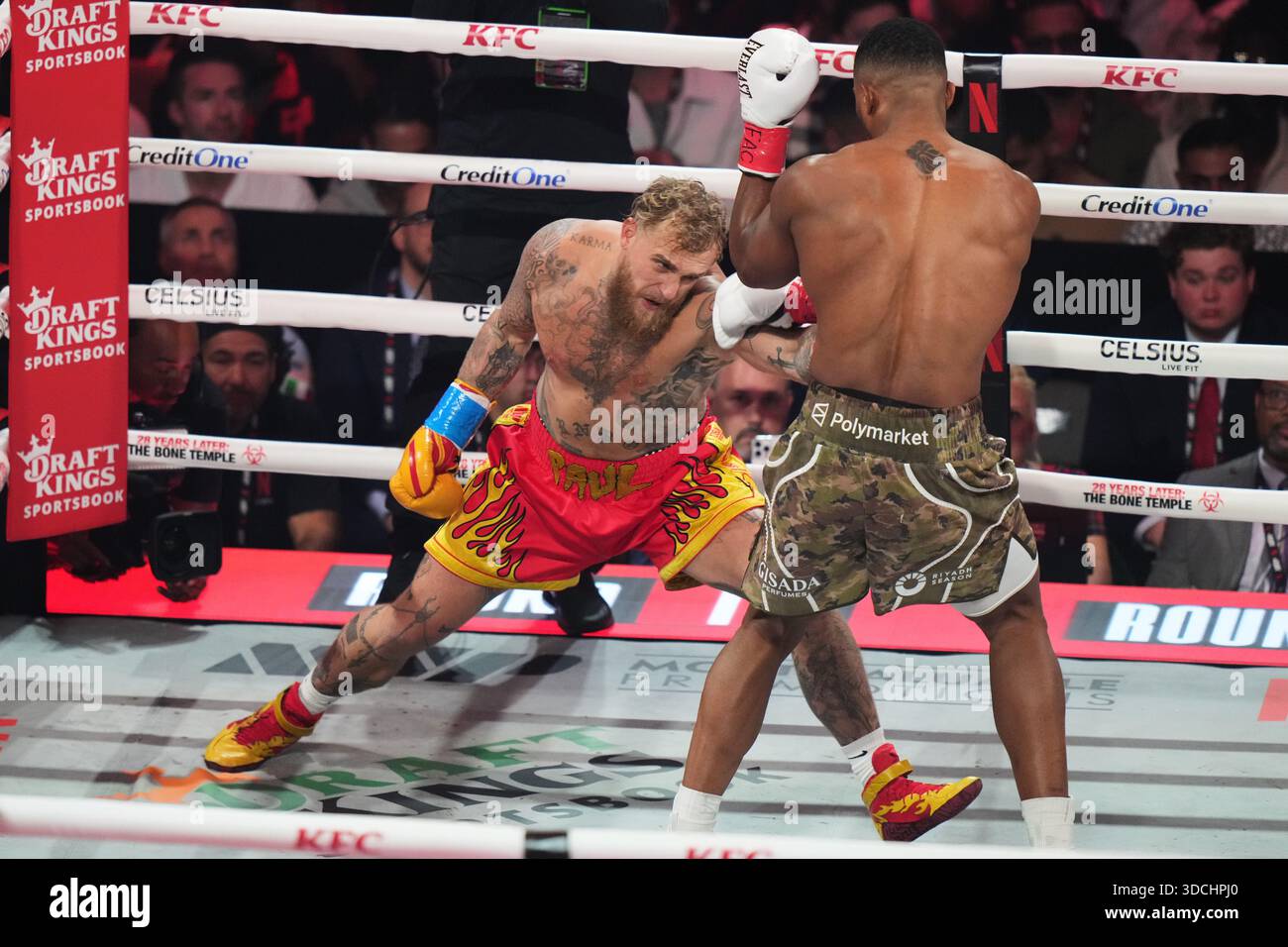 Jake Paul, left, and Anthony Joshua, right, compete during their ...