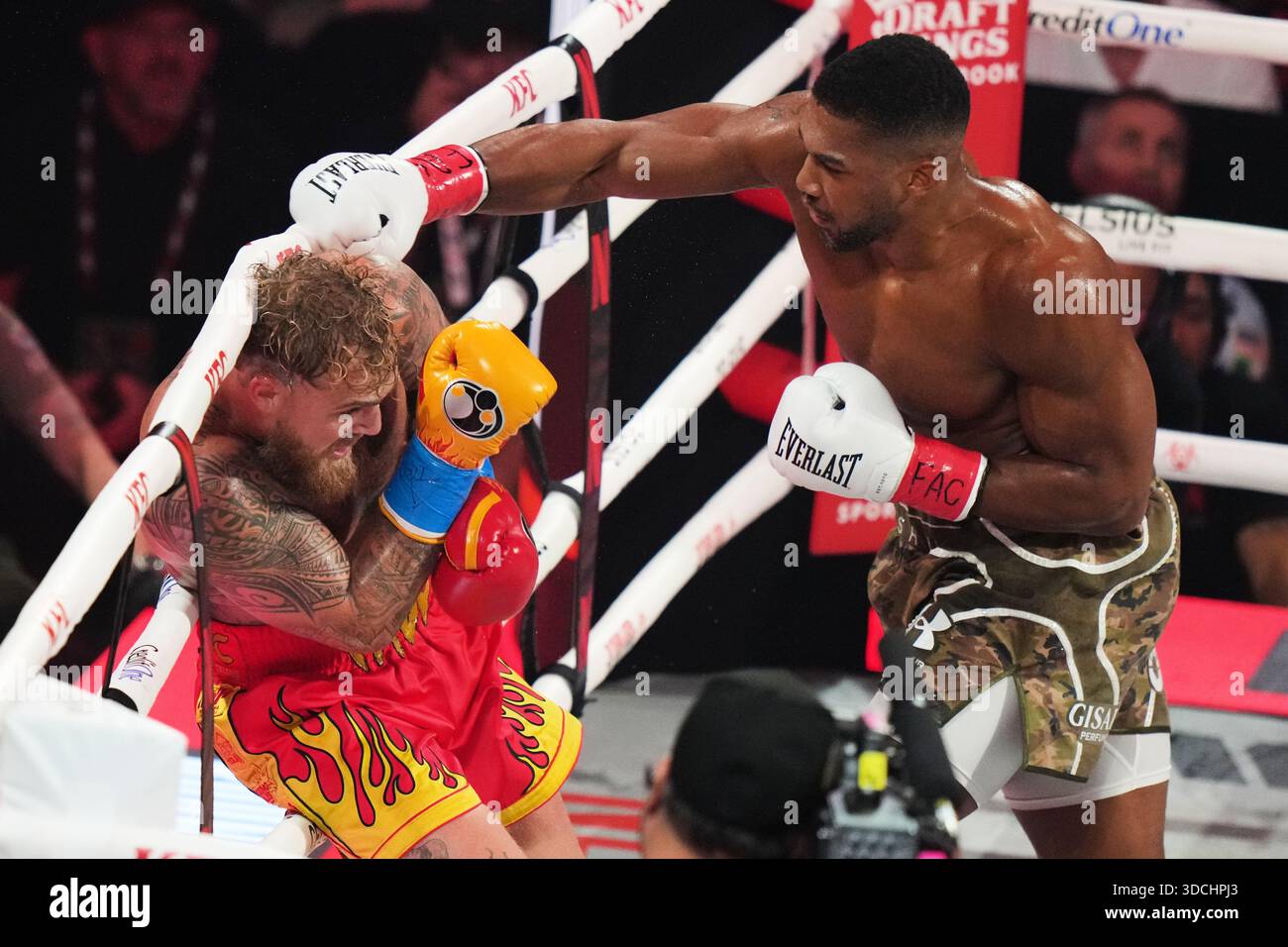 Jake Paul, left, and Anthony Joshua, right, compete during their ...