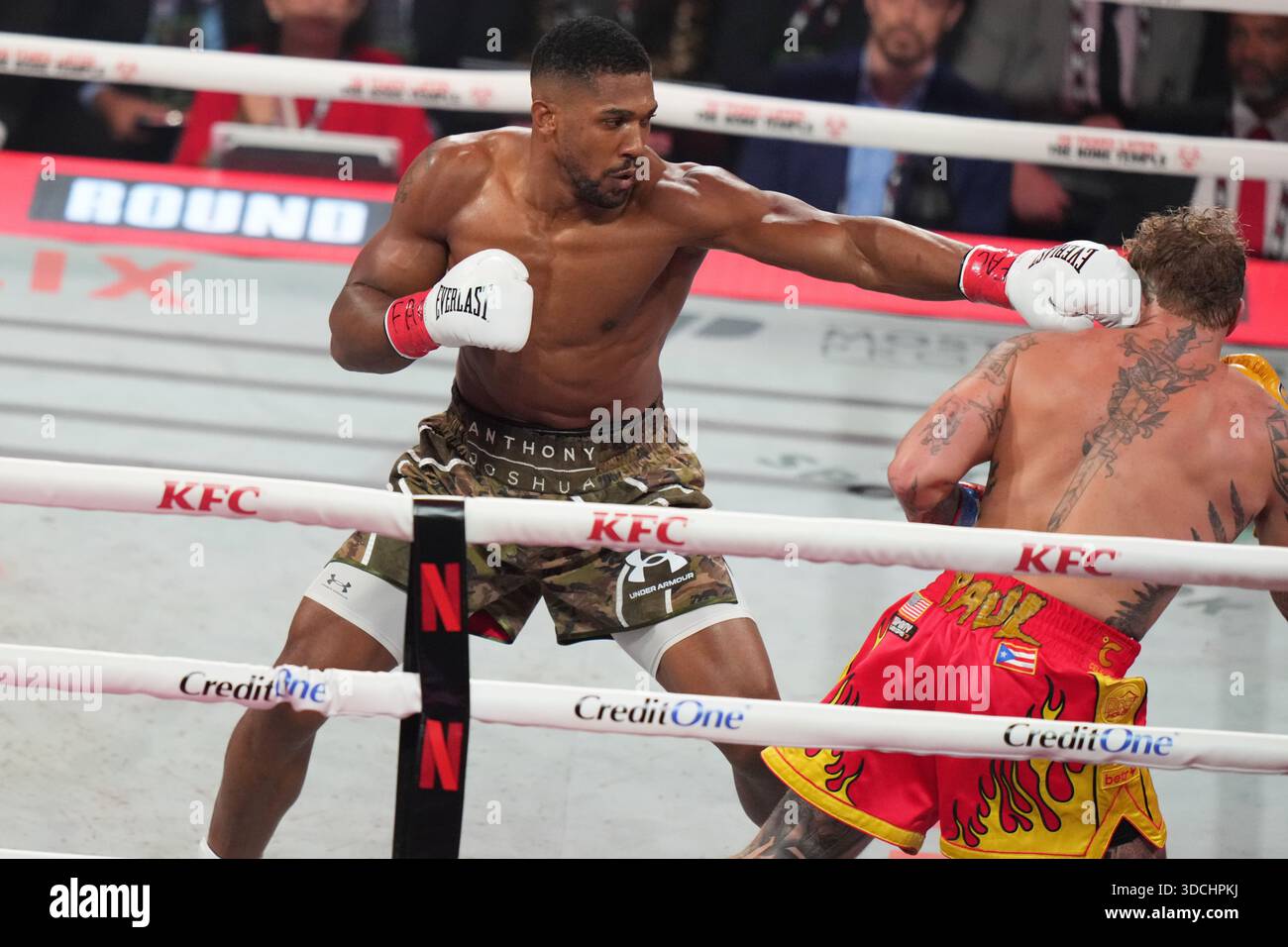 Anthony Joshua, left, and Jake Paul, right, compete during their ...