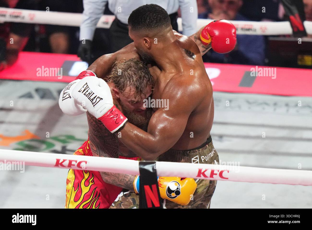 Jake Paul, left, and Anthony Joshua, right, compete during their ...