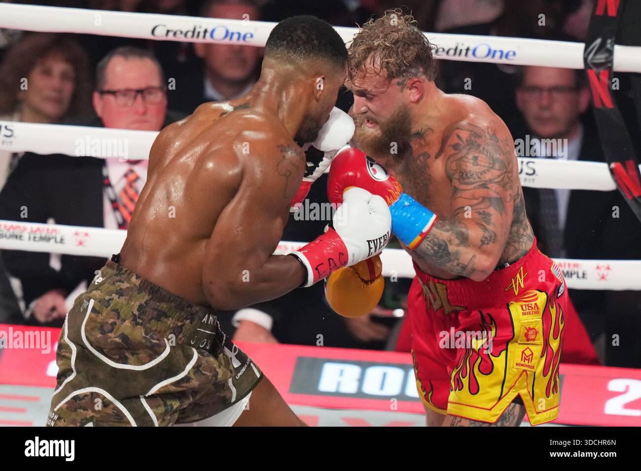 Anthony Joshua, left, and Jake Paul, right, compete during their ...